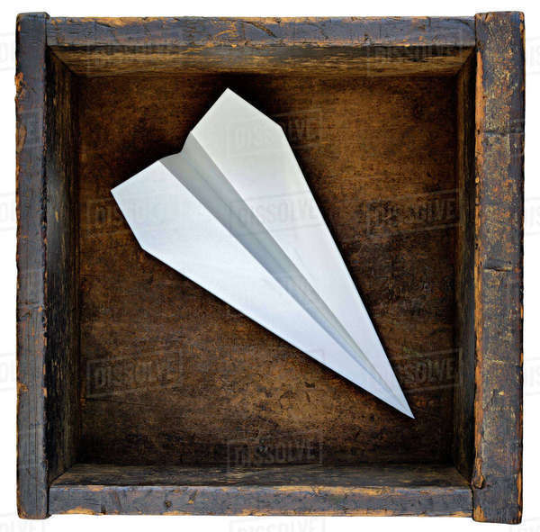 Paper airplane in wooden box - Stock Photo - Dissolve