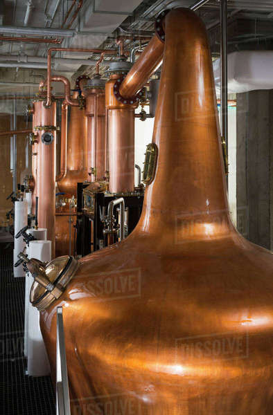 Copper stills in distillery - Stock Photo - Dissolve
