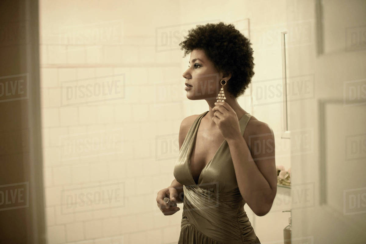 Woman getting ready in bathroom - Stock Photo - Dissolve