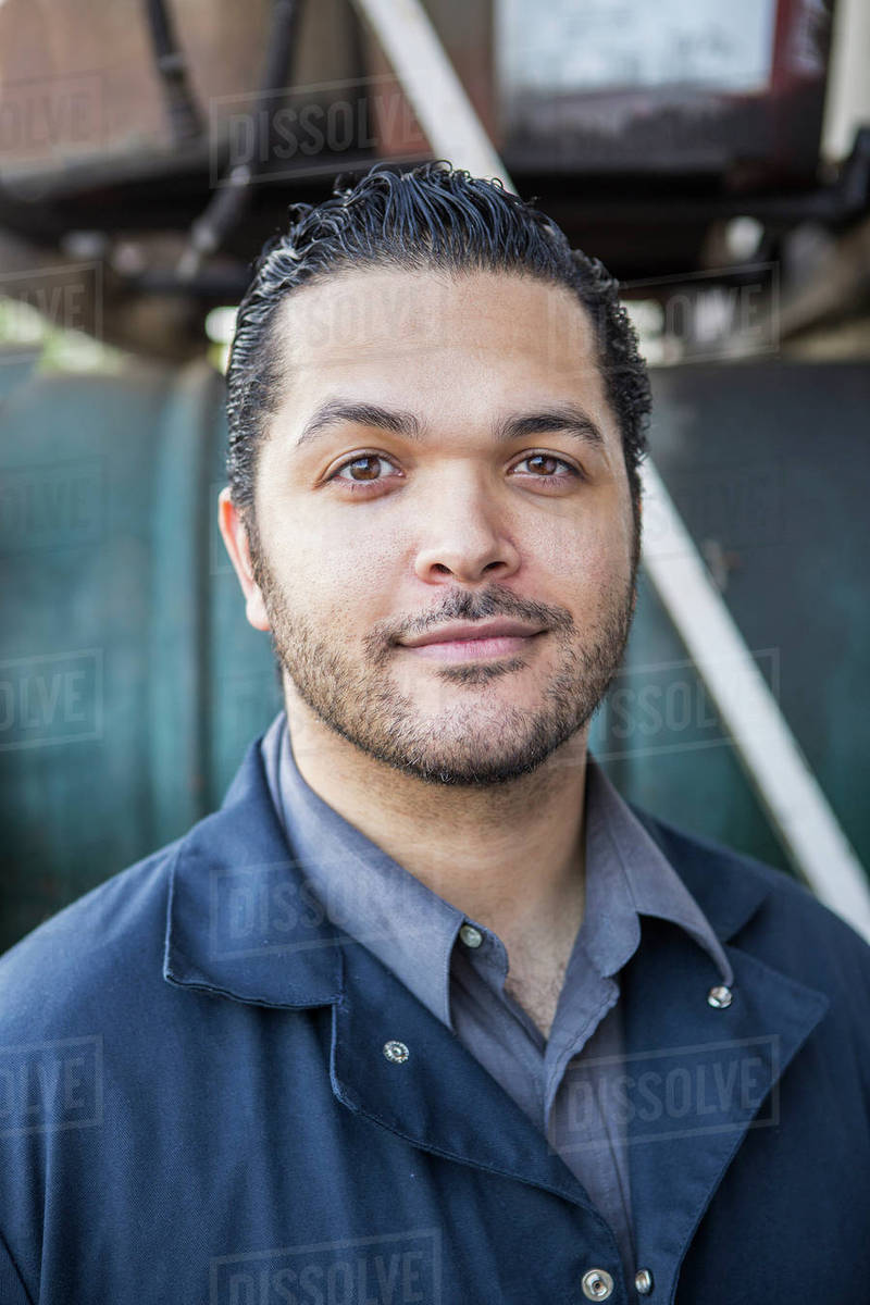 Hispanic blue collar worker smiling outdoors - Royalty-free Stock Photo ...