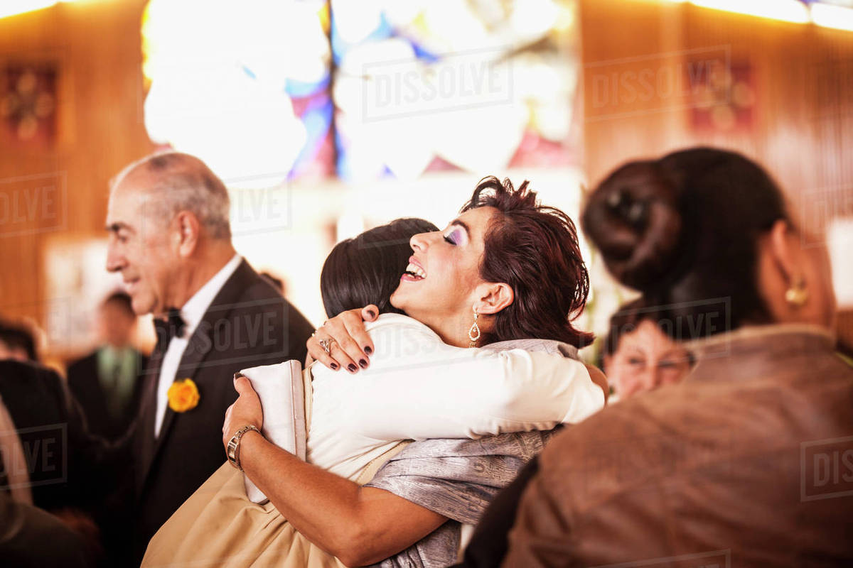 Hispanic family hugging at wedding reception - Royalty-free Stock Photo ...