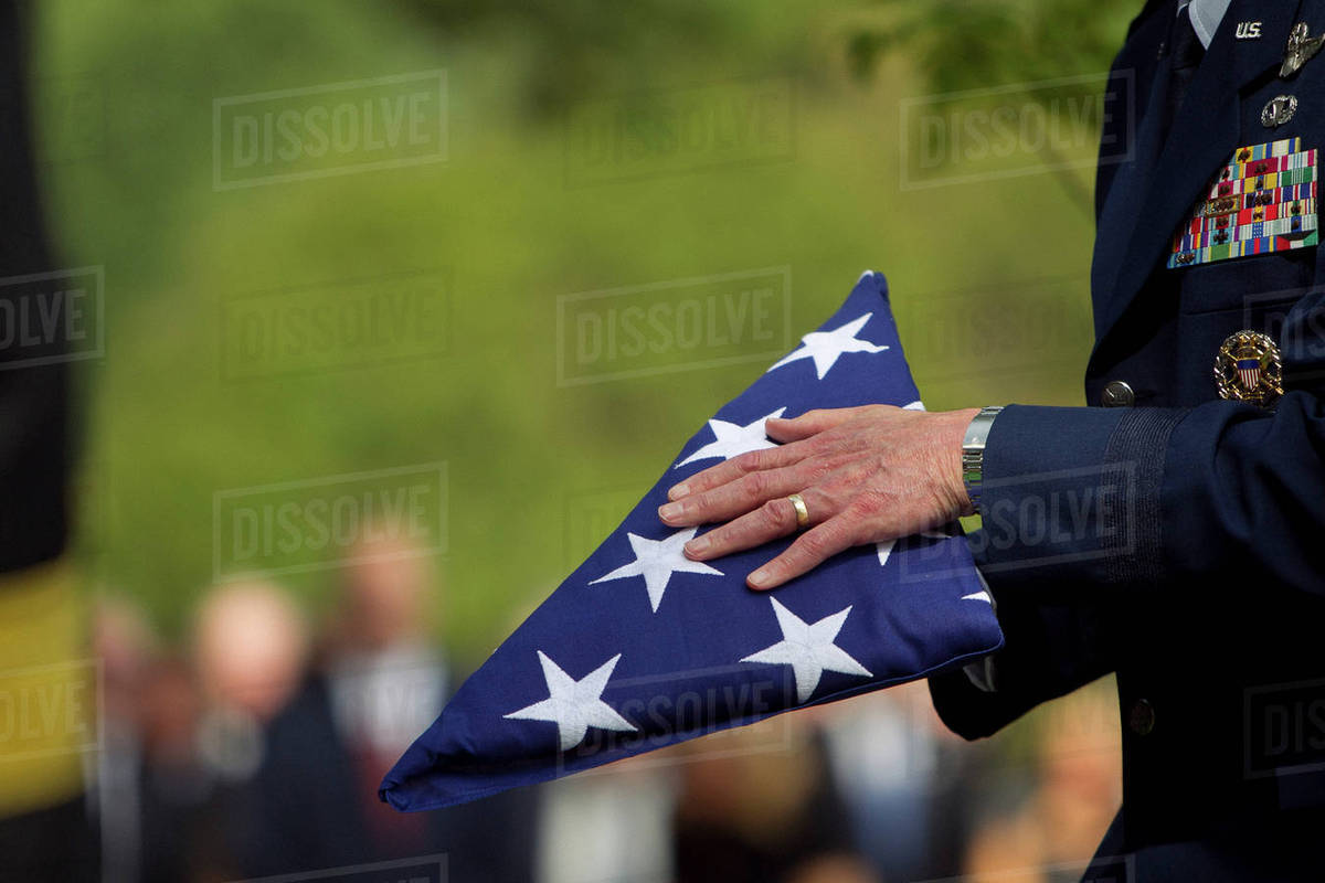Soldier folding flag at military funeral - Royalty-free Stock Photo ...