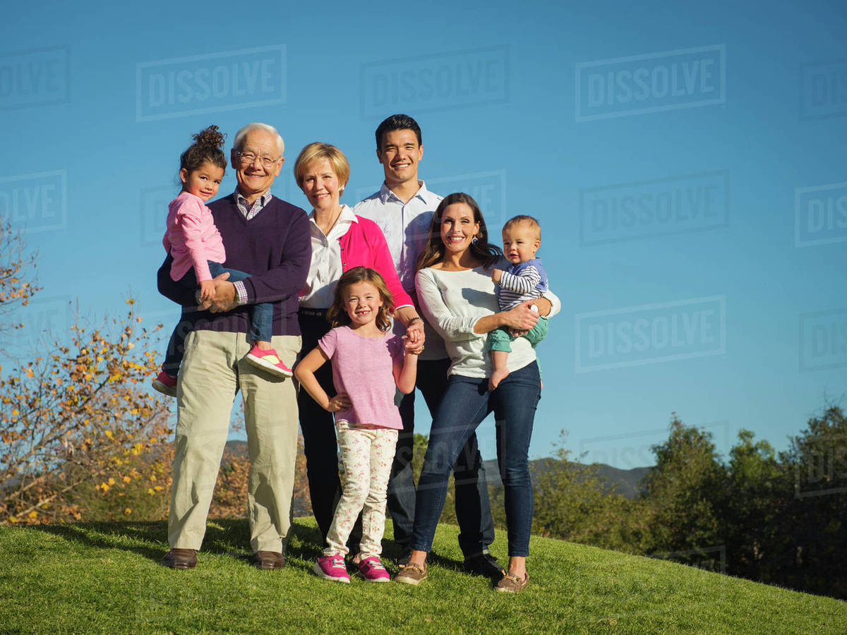 Family smiling together outdoors - Royalty-free Stock Photo | Dissolve