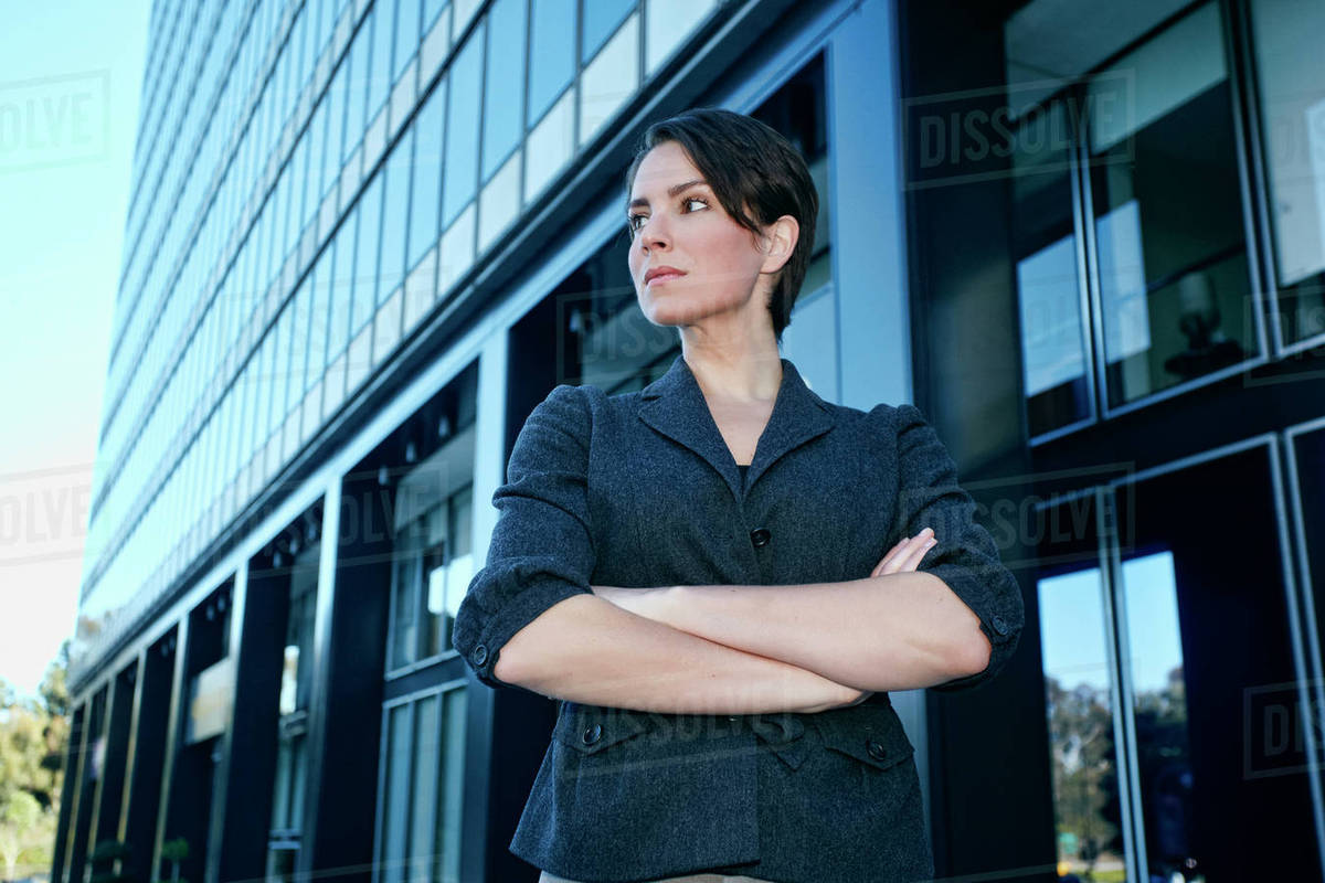 Caucasian businesswoman standing with arms crossed outdoors - Royalty ...