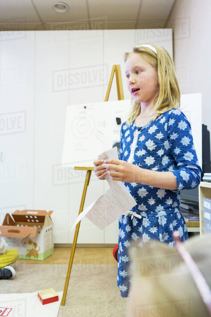 Caucasian girl giving presentation to classmates - Royalty-free Stock ...