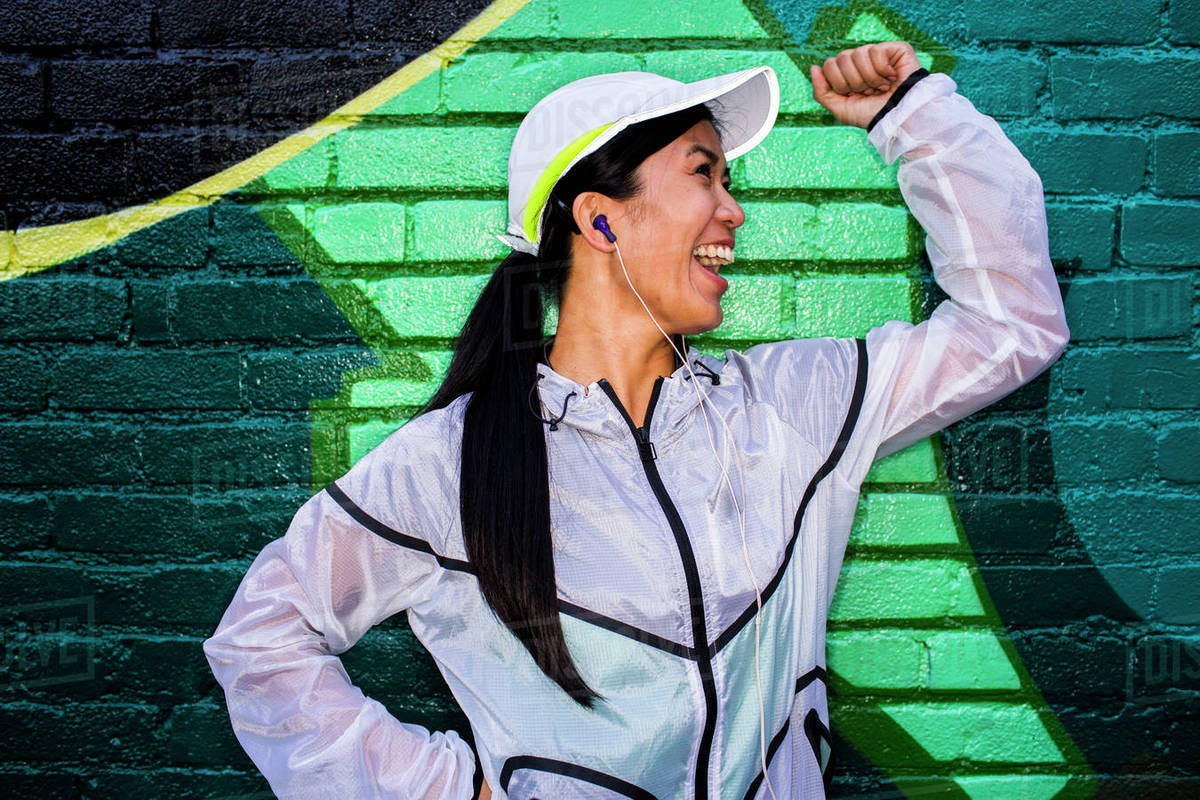 Asian runner standing near graffiti wall - Royalty-free Stock Photo ...