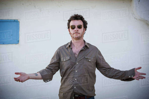 Caucasian man standing with arms outstretched outdoors - Royalty-free ...