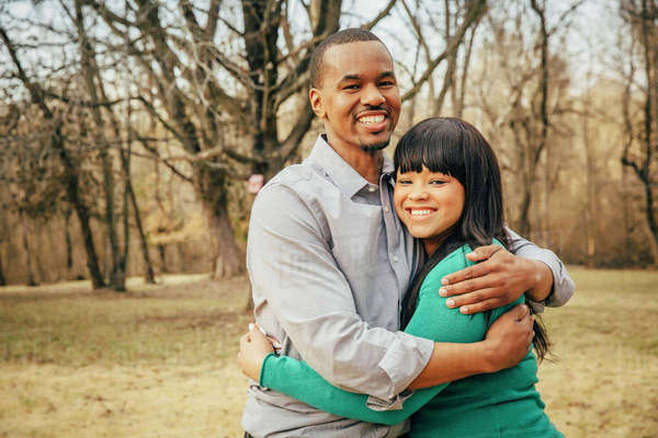 Black father and daughter hugging outdoors - Royalty-free Stock Photo ...