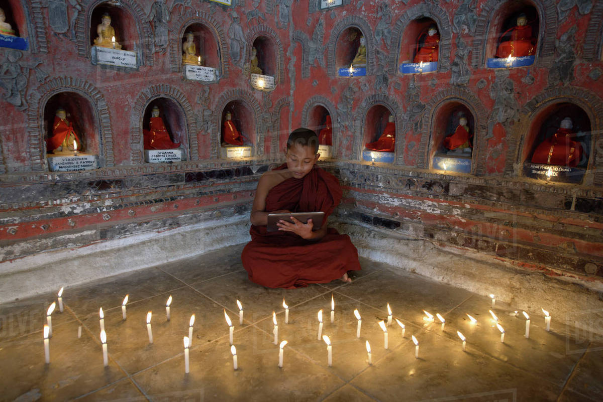 Asian monks-in-training using digital tablet in ancient temple ...