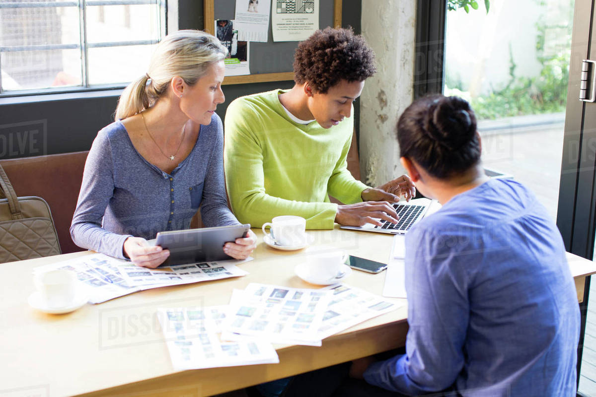 Business people using technology in office meeting - Stock Photo - Dissolve