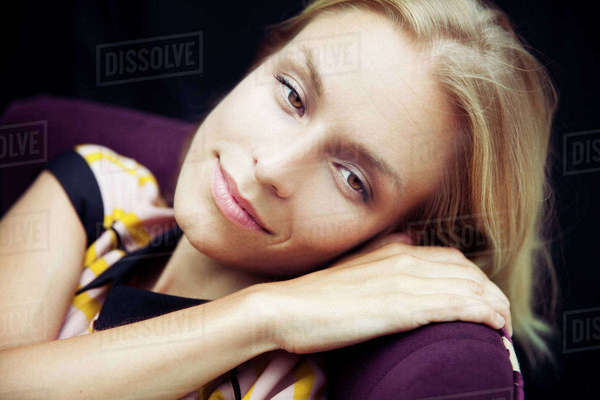 Caucasian woman resting head on chair - Stock Photo - Dissolve