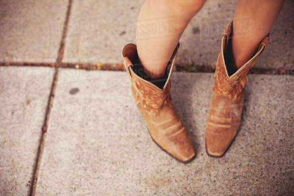 High angle view of woman wearing cowboy boots - Stock Photo - Dissolve