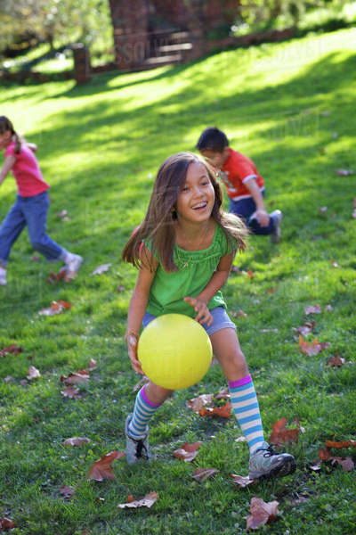 Children playing with ball in park - Stock Photo - Dissolve
