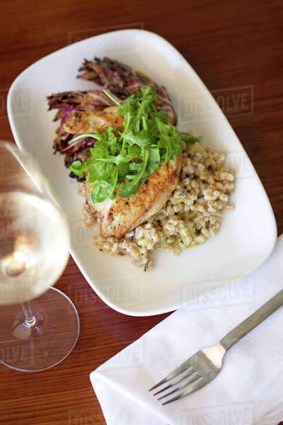 Close up of plate of fish dinner with white wine - Stock Photo - Dissolve