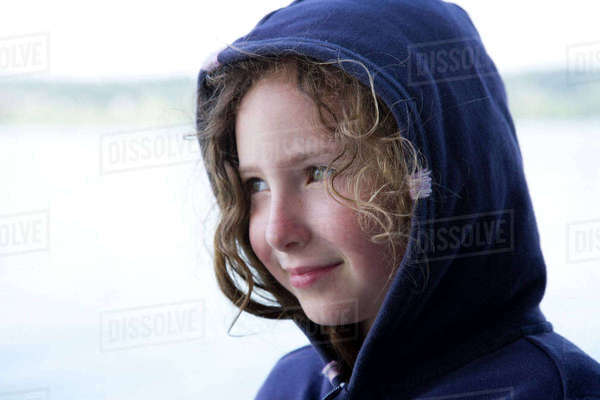 Caucasian girl wearing hood outdoors - Stock Photo - Dissolve
