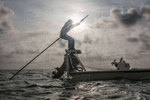 Caucasian fisherman rowing boat on ocean - Royalty-free Stock Photo ...
