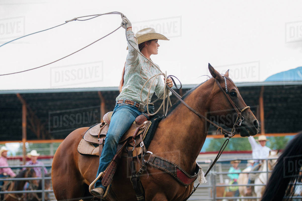 Caucasian cowgirl twirling lasso in rodeo - Royalty-free Stock Photo ...