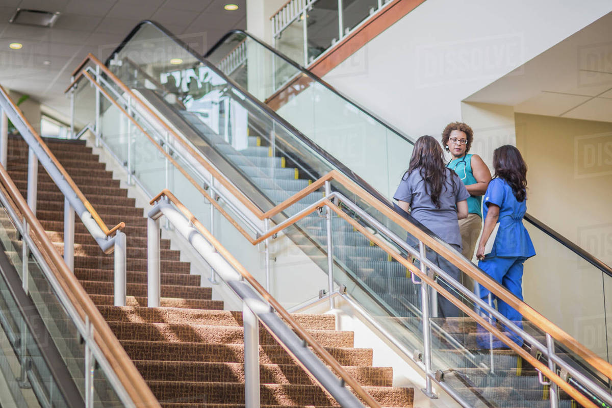 Nurses and doctor on hospital steps - Stock Photo - Dissolve