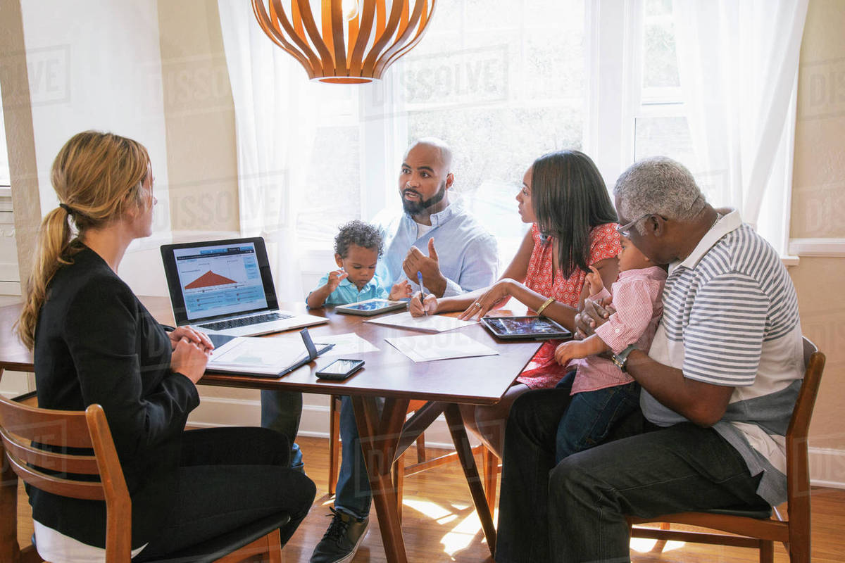 Financial advisor talking to clients - Stock Photo - Dissolve