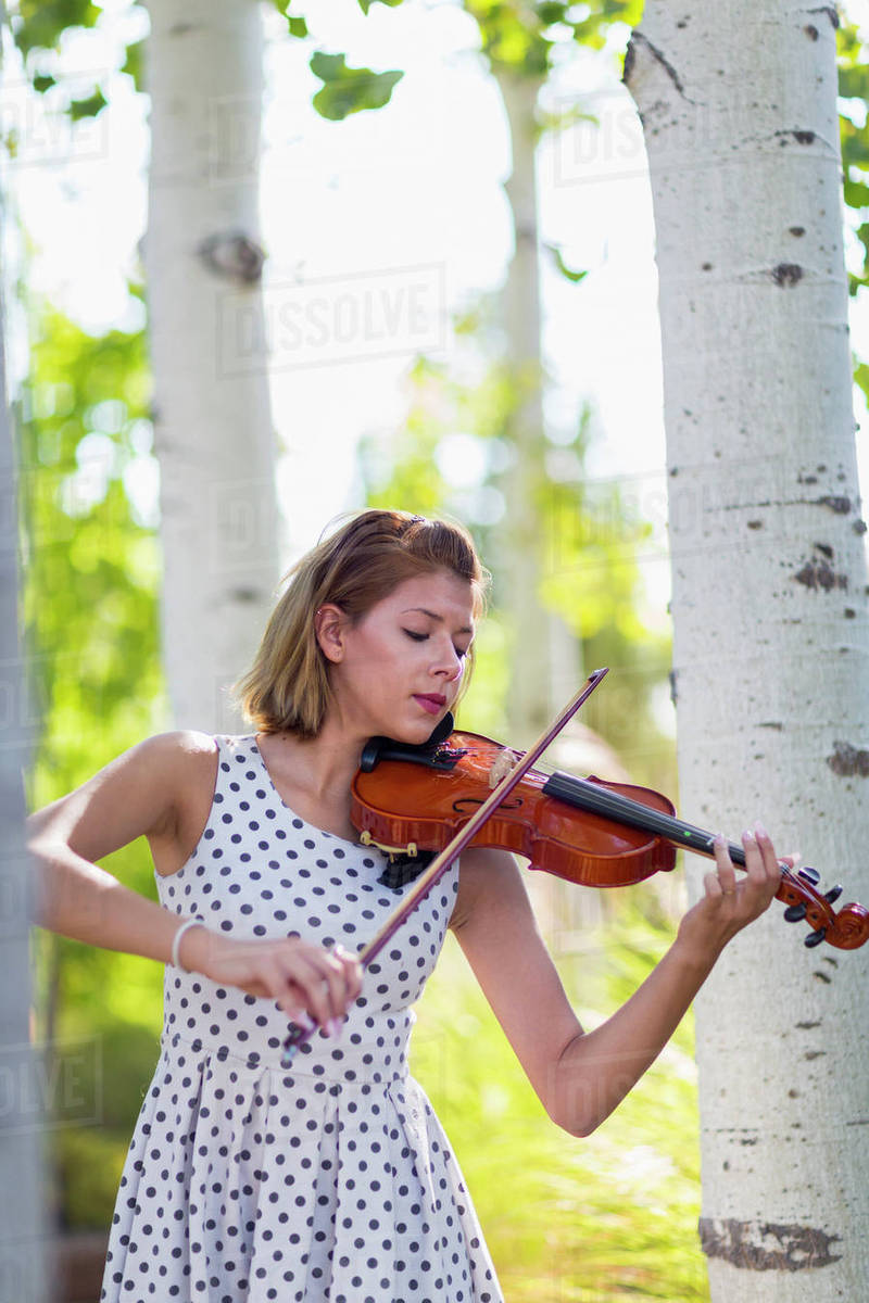 Mixed race musician playing violin outdoors - Stock Photo - Dissolve
