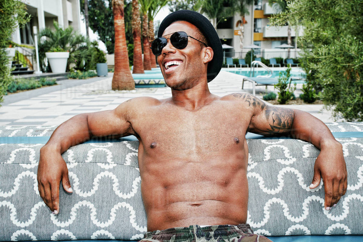 African American man sitting outdoors - Royalty-free Stock Photo | Dissolve