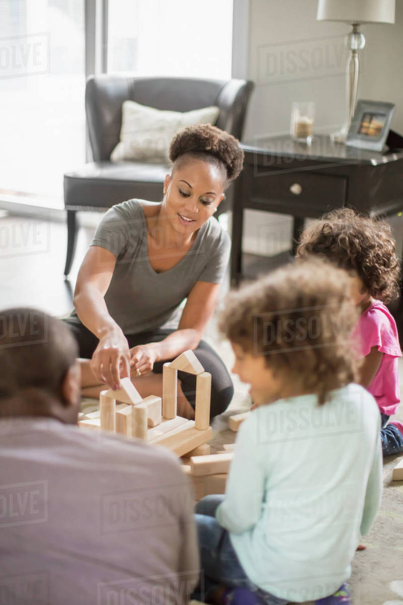 Family playing with building blocks in living room - Royalty-free Stock ...