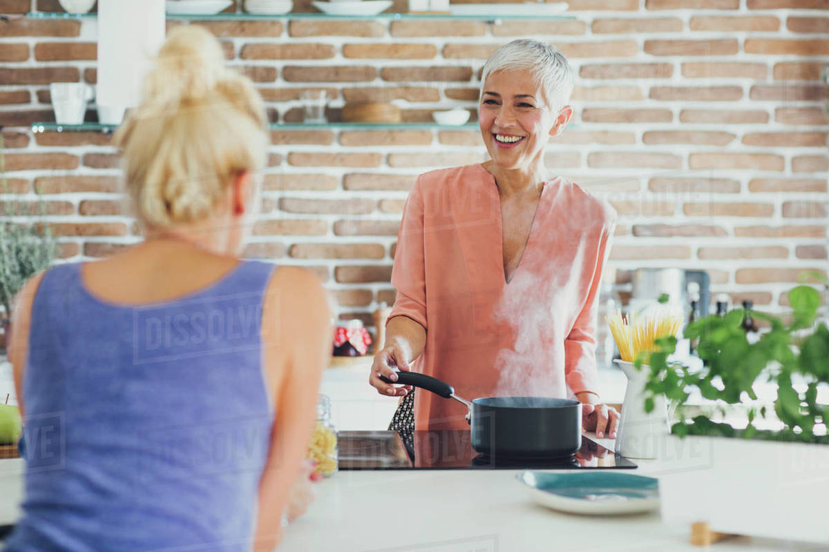 Women talking in kitchen - Royalty-free Stock Photo | Dissolve