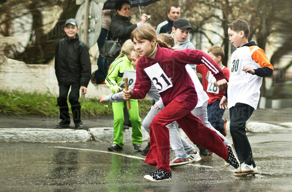 Caucasian children racing on street - Stock Photo - Dissolve