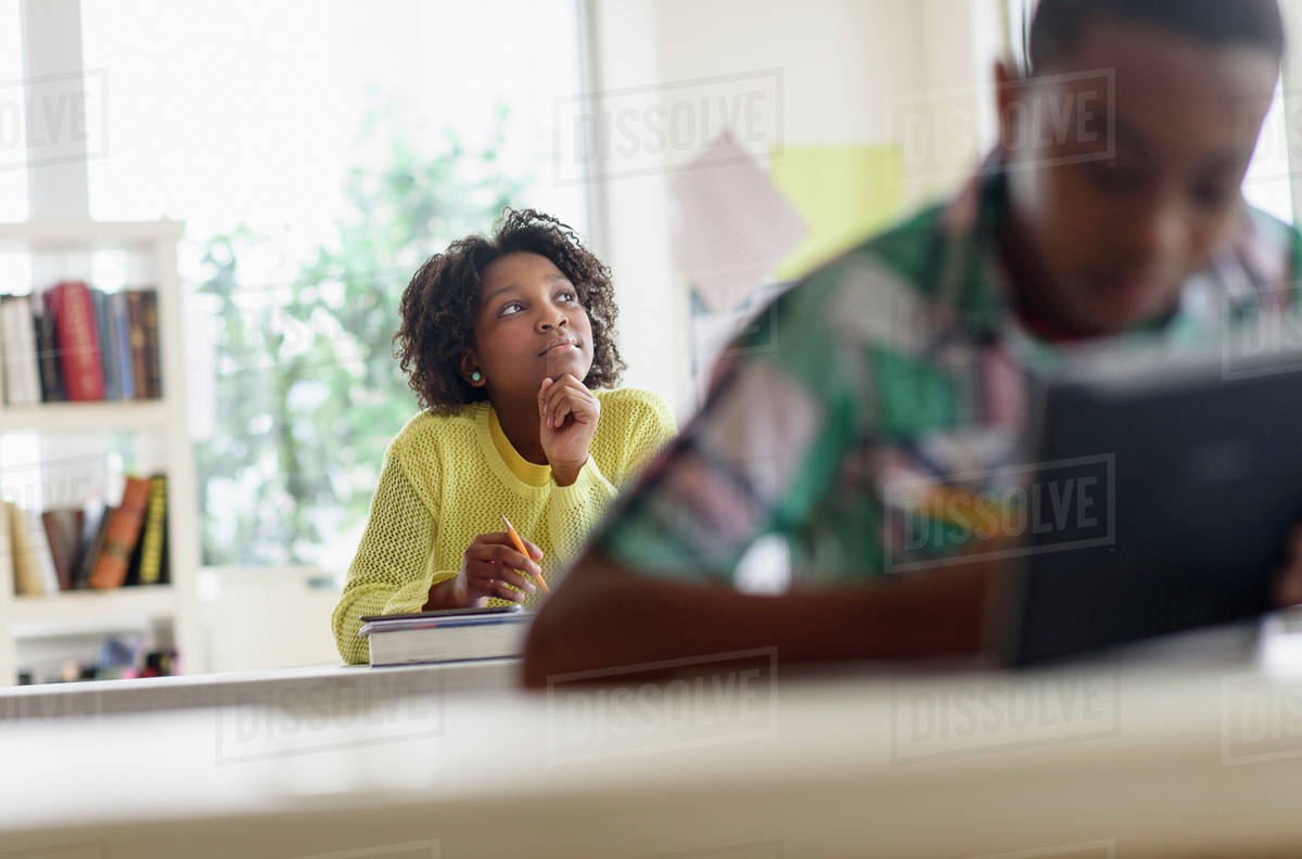 Black student thinking in classroom - Royalty-free Stock Photo | Dissolve