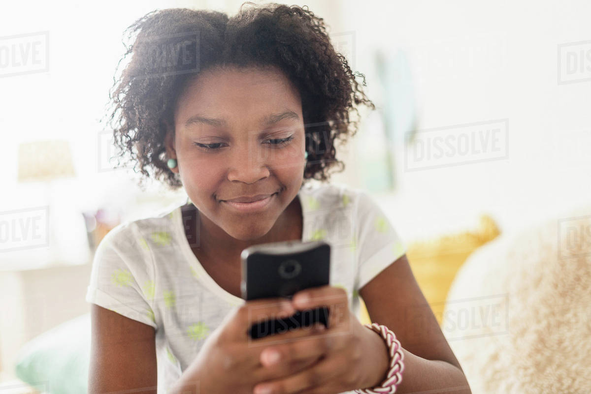 Close up of Black girl using cell phone - Royalty-free Stock Photo ...