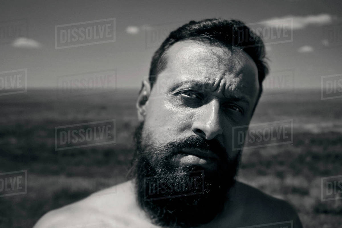 Caucasian man with beard in field - Royalty-free Stock Photo | Dissolve