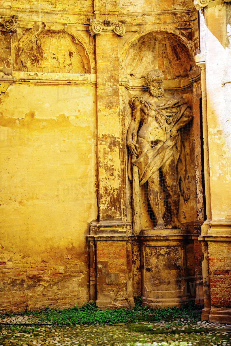 Worn statue in alcove - Royalty-free Stock Photo | Dissolve