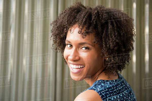 Smiling Black woman looking over shoulder - Royalty-free Stock Photo ...