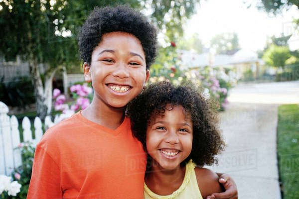 Smiling Mixed Race brother and sister hugging outdoors - Royalty-free ...