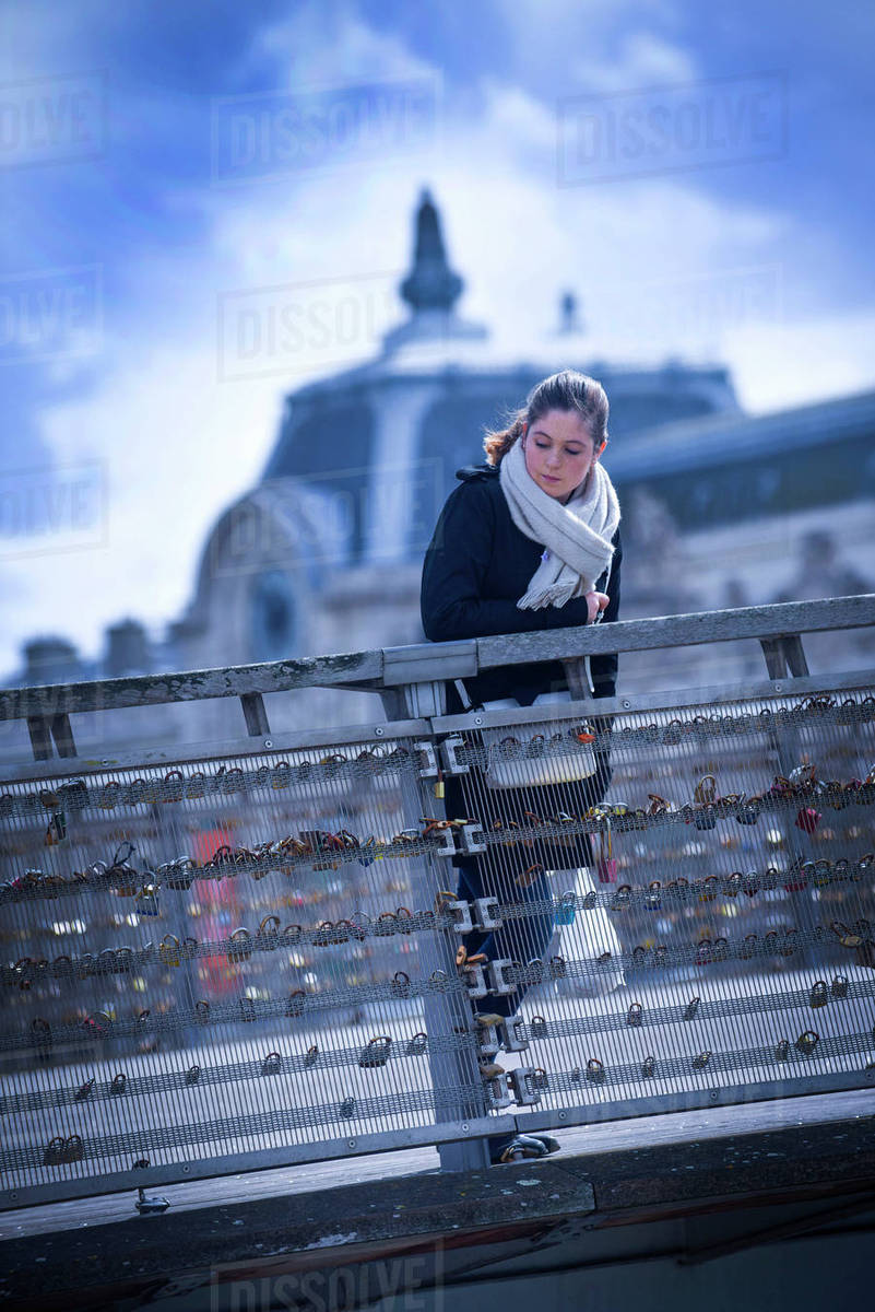 Girl looking over bridge railing - Stock Photo - Dissolve