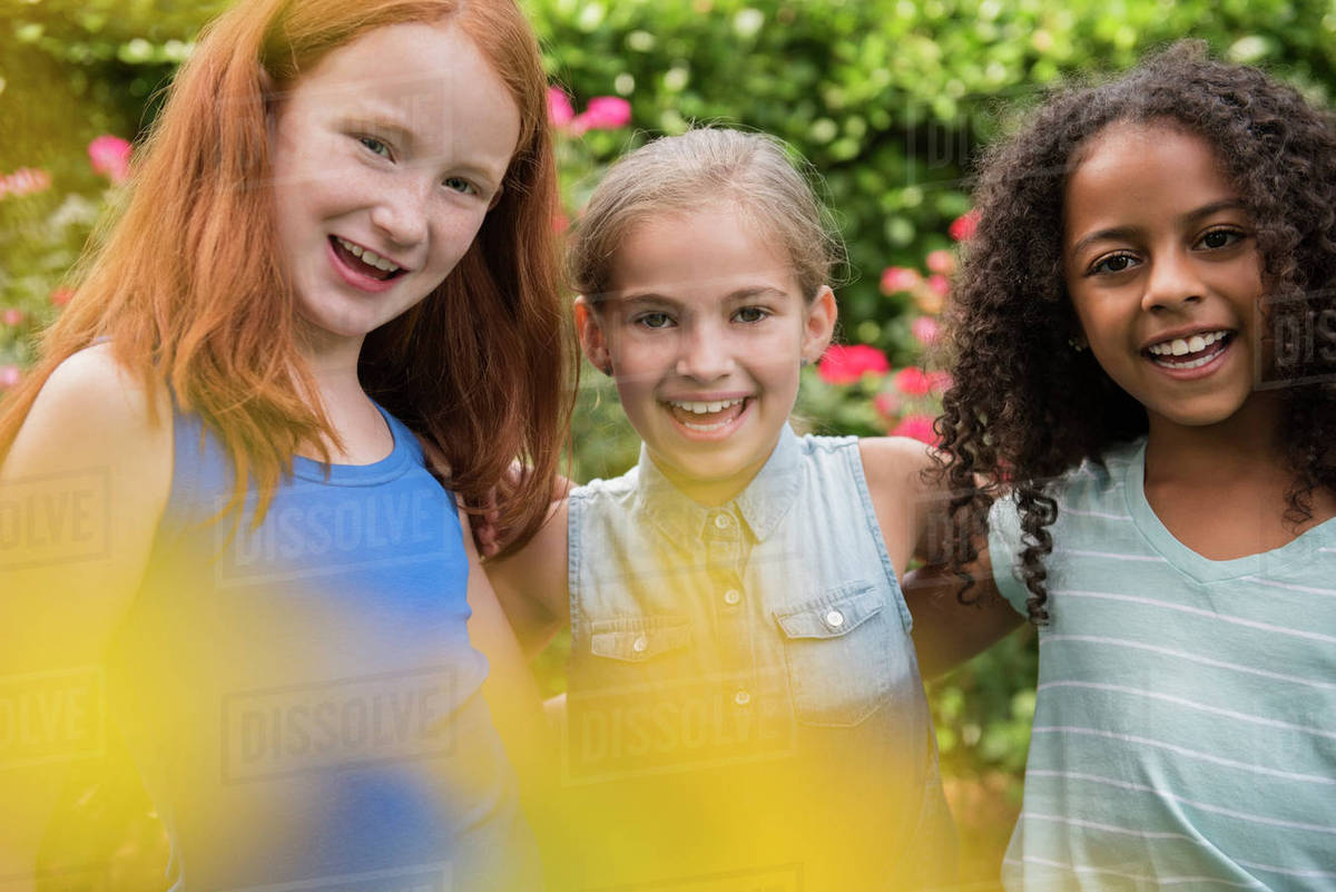 Portrait of smiling girls outdoors - Stock Photo - Dissolve