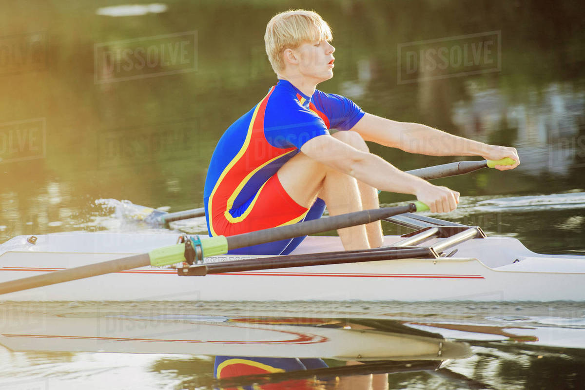 Caucasian man rowing on river - Royalty-free Stock Photo | Dissolve