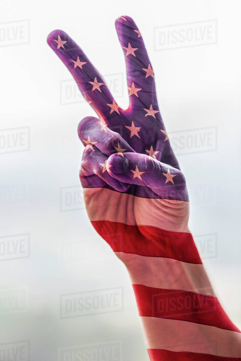 Hand of Caucasian man with American flag gesturing peace - Royalty-free ...