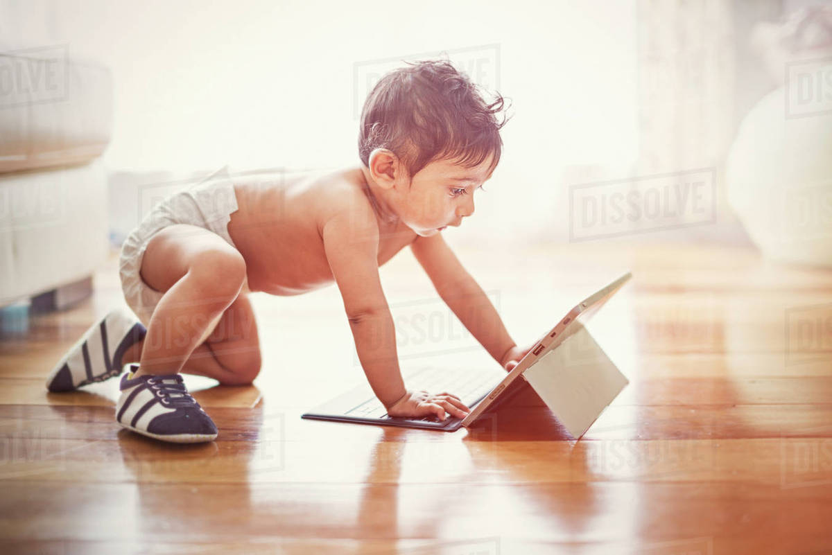 Indian baby boy crawling on floor with digital tablet - Royalty-free ...