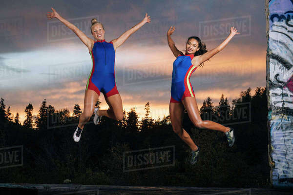Runners jumping for joy - Stock Photo - Dissolve