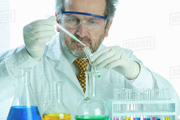 Scientist mixing liquid in laboratory - Royalty-free Stock Photo | Dissolve