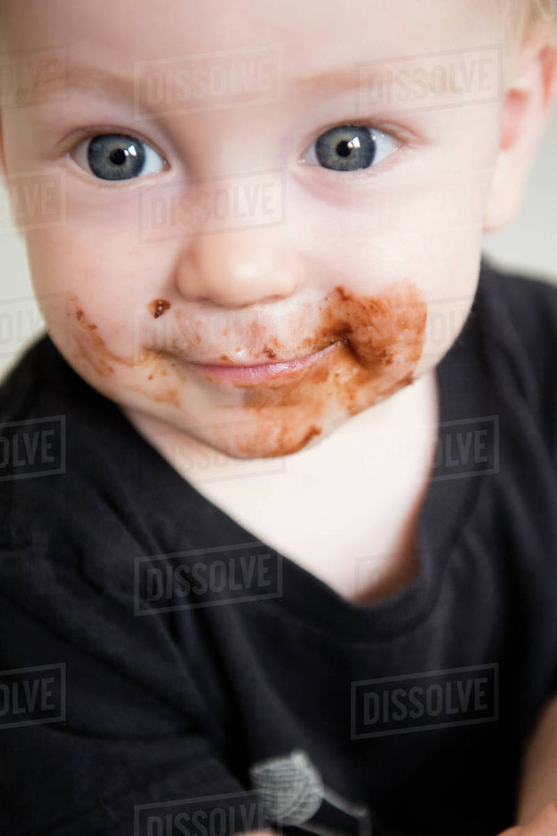 Caucasian baby boy with messy face - Royalty-free Stock Photo | Dissolve
