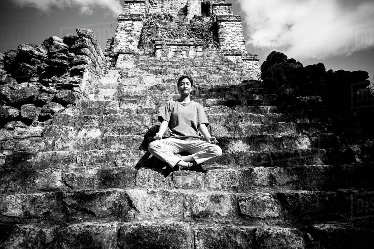 Japanese woman meditating on staircase to temple - Royalty-free Stock ...