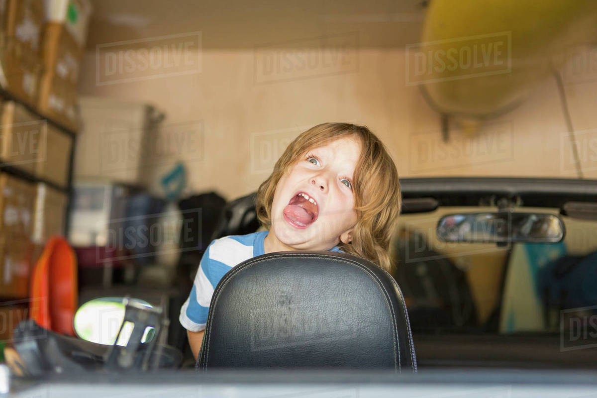 Caucasian boy making a face in convertible car - Royalty-free Stock ...