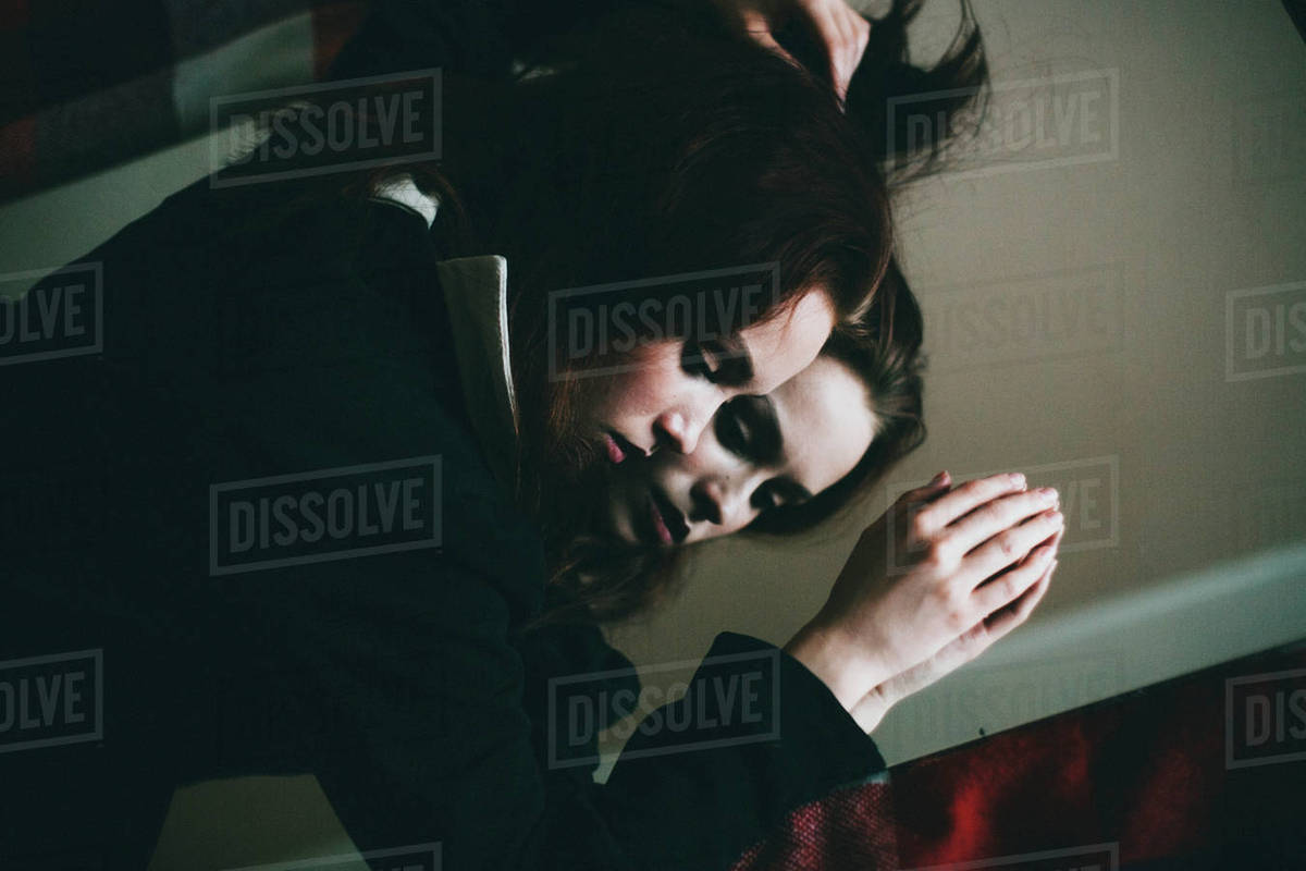 Caucasian woman laying on mirror - Stock Photo - Dissolve