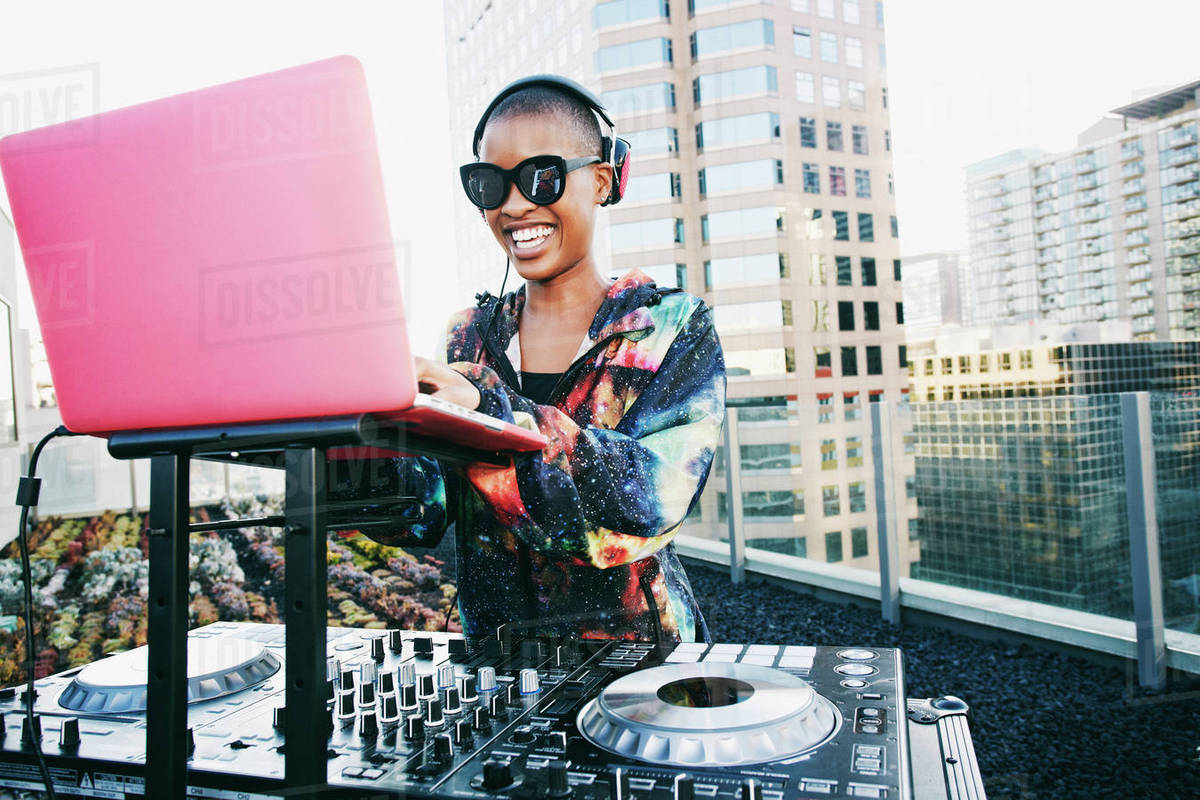 Smiling Black DJ on urban rooftop - Royalty-free Stock Photo | Dissolve