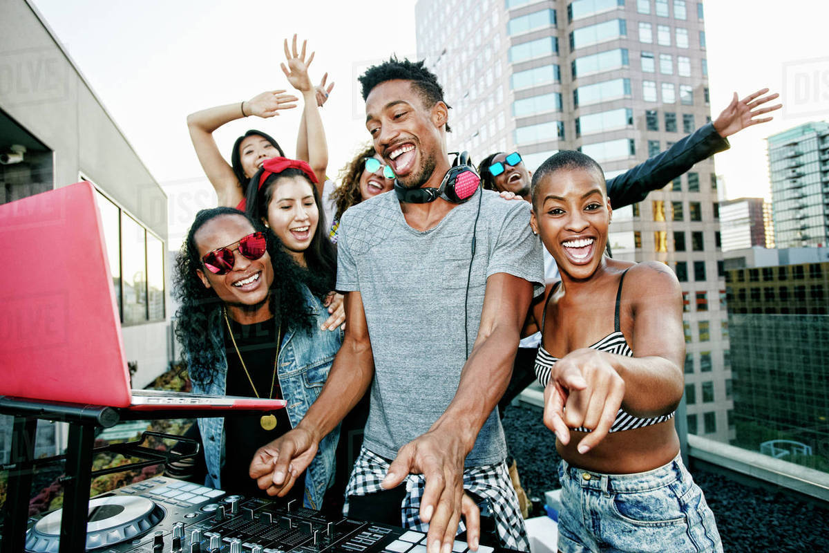 Friends posing with DJ on urban rooftop - Royalty-free Stock Photo ...
