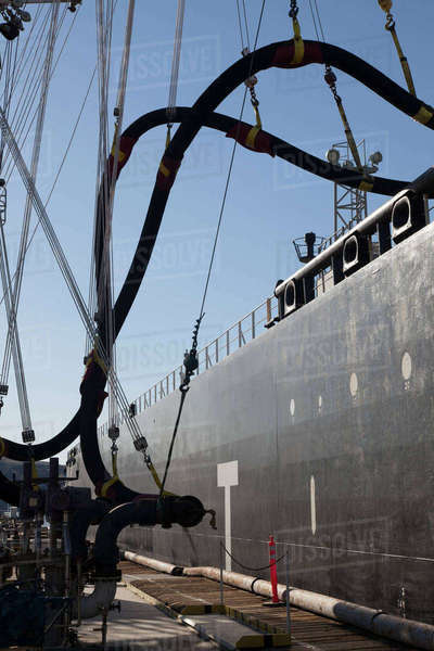 Pipes connecting hoses to freighter at port - Royalty-free Stock Photo ...