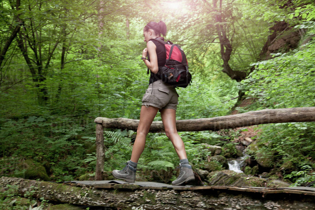 Caucasian woman hiking in forest - Royalty-free Stock Photo | Dissolve