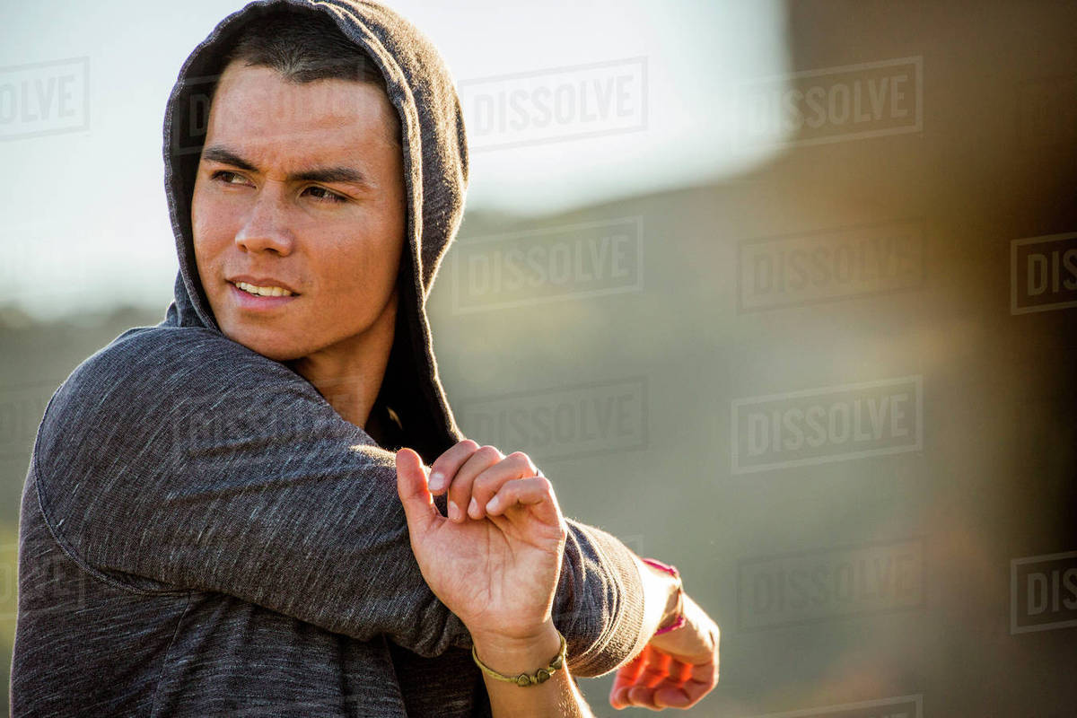 Serious Mixed Race man stretching arms - Royalty-free Stock Photo ...